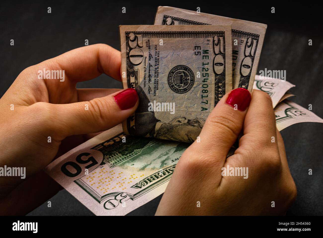 Closeup of a woman counting dollars Stock Photo - Alamy