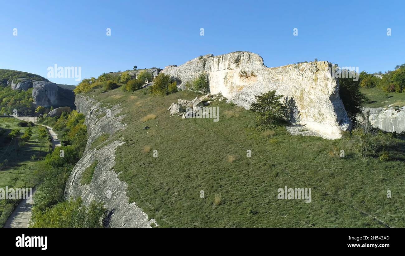 Rock above gorge. Shot. Top view of landscape of stone ridge hills ...