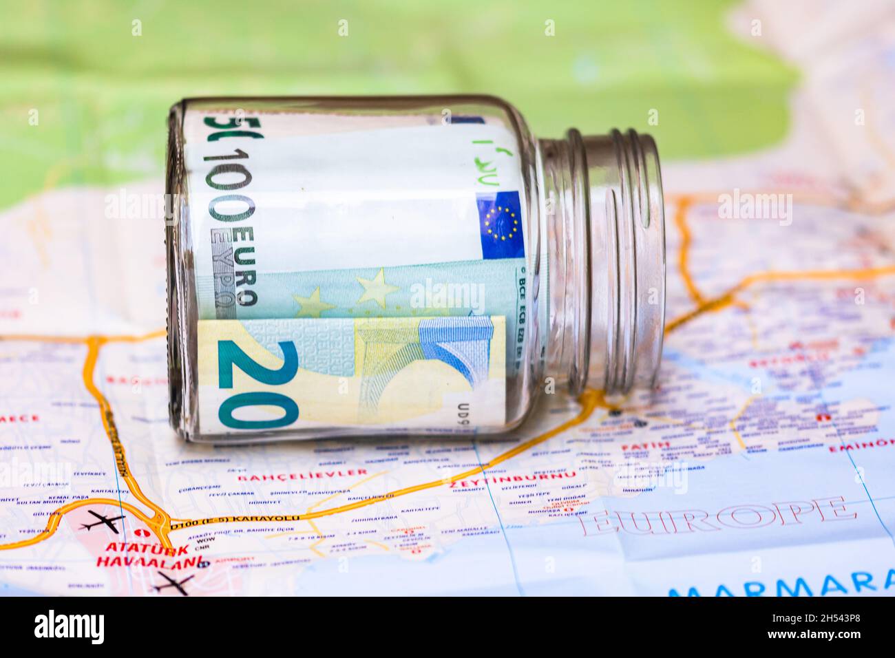 Composition with saving money banknotes in a glass jar on a map Stock ...