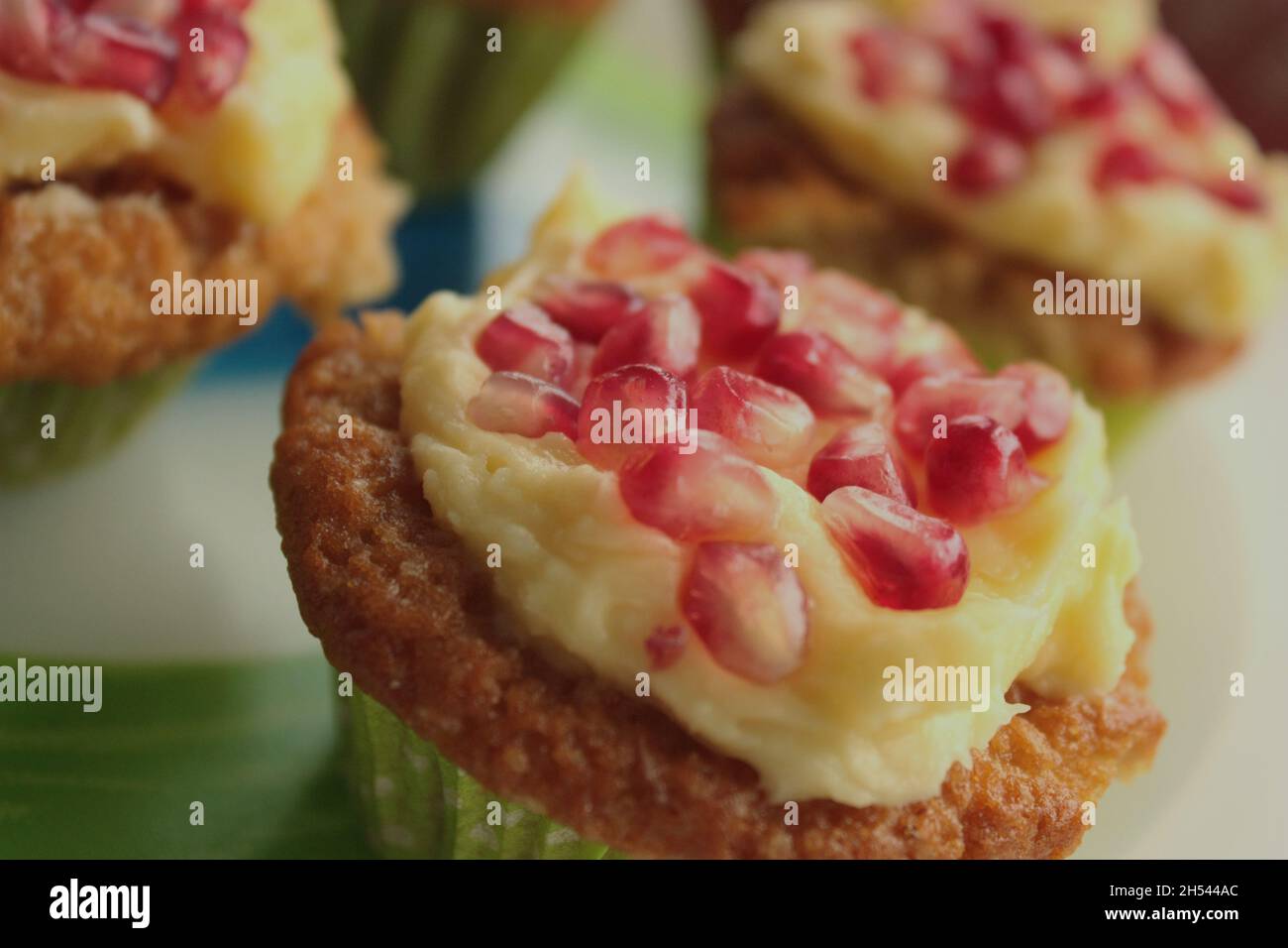 cupcakes with frosted topping and pomegranate seeds Stock Photo - Alamy