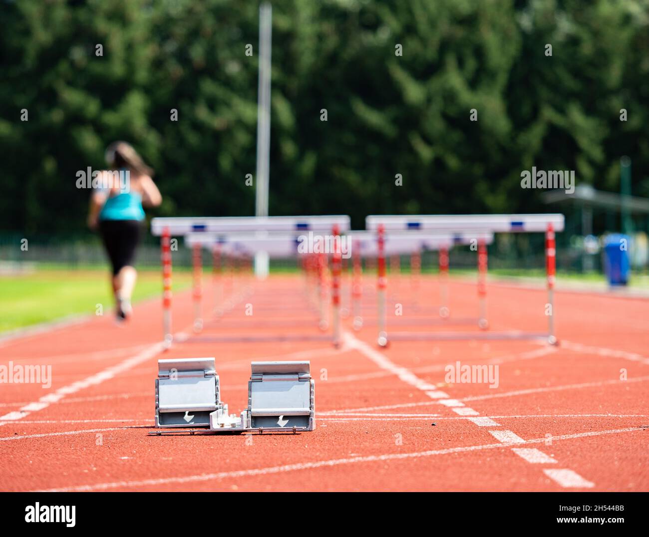 Running track with blurry running person, strarting blocks and athletic ...