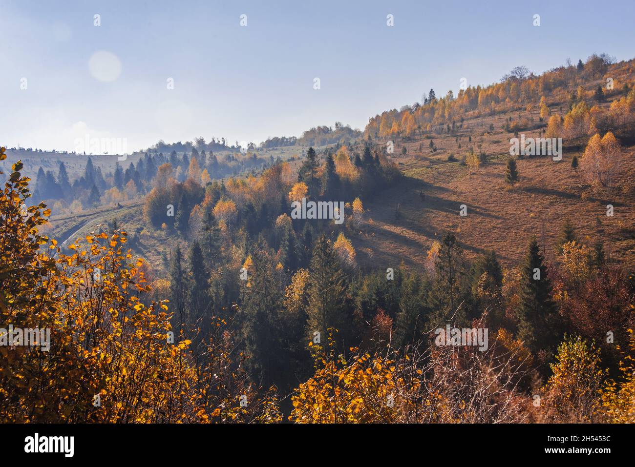 View of hills of Water Dividing ridge covered in red, orange and yellow ...