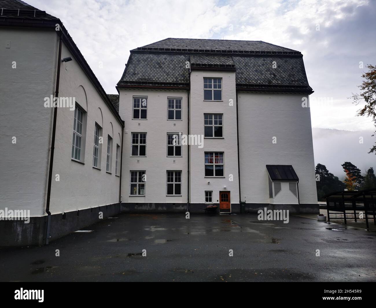 Low angle shot of a school white building after raining with a ...