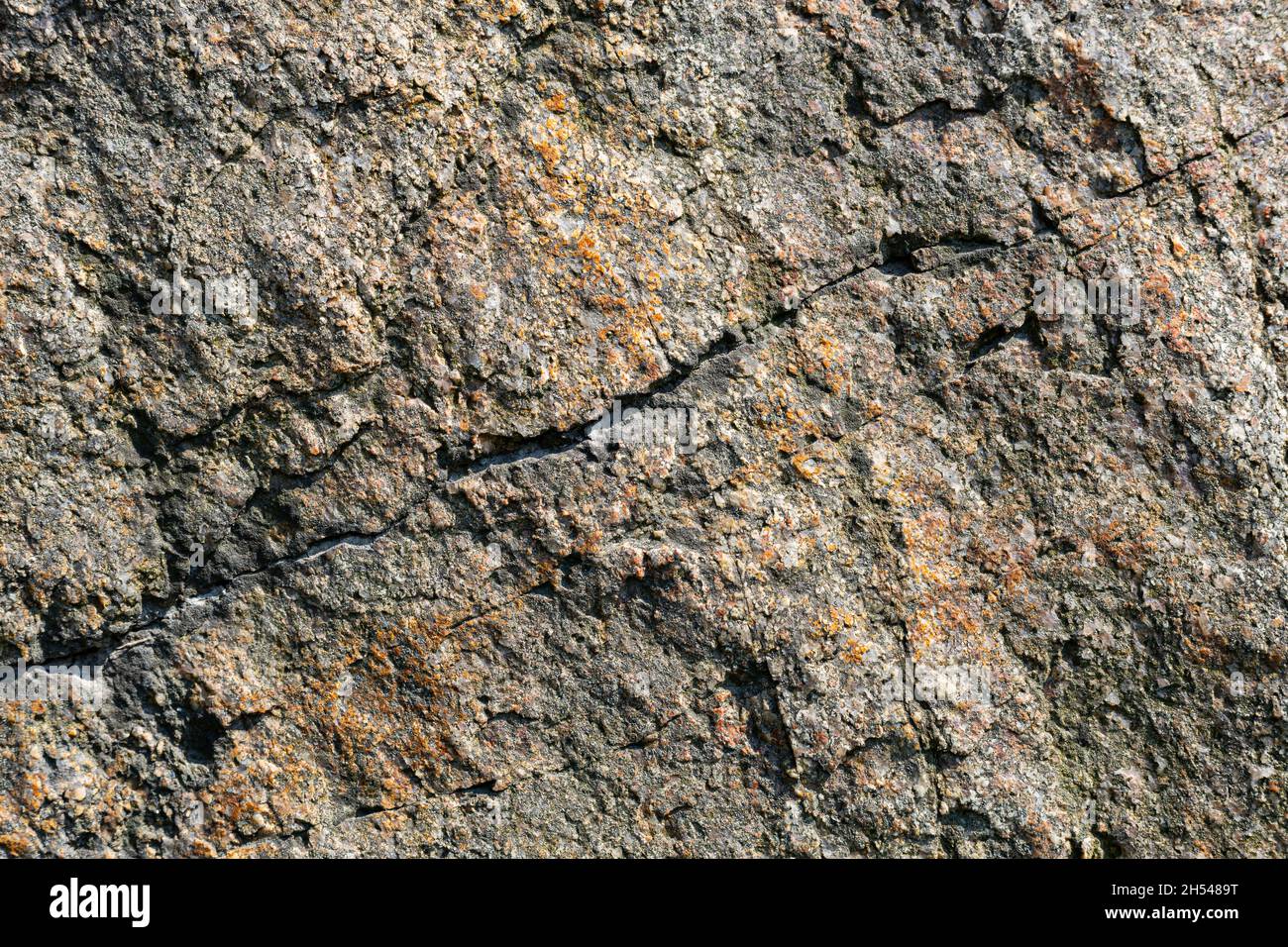 Texture of granite rock. Cracked stone surface from weathering. Close up of granite surface ...