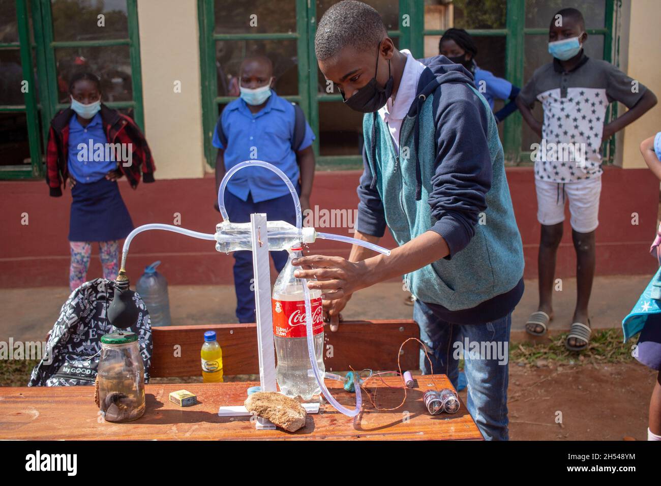 Student doing grey water purification experiment using recycled ...