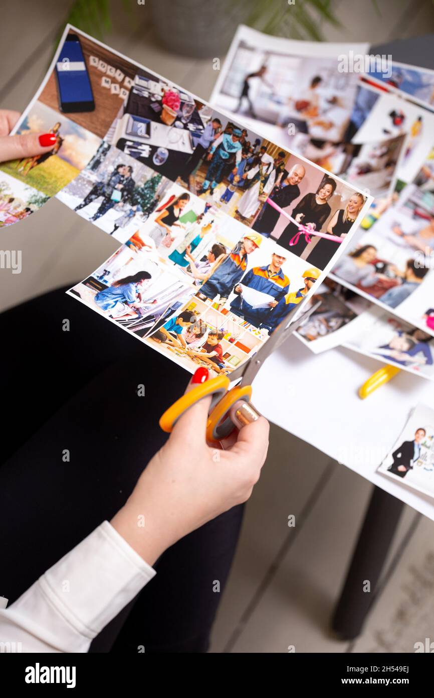 a girl cuts out a magazine with scissors Stock Photo - Alamy