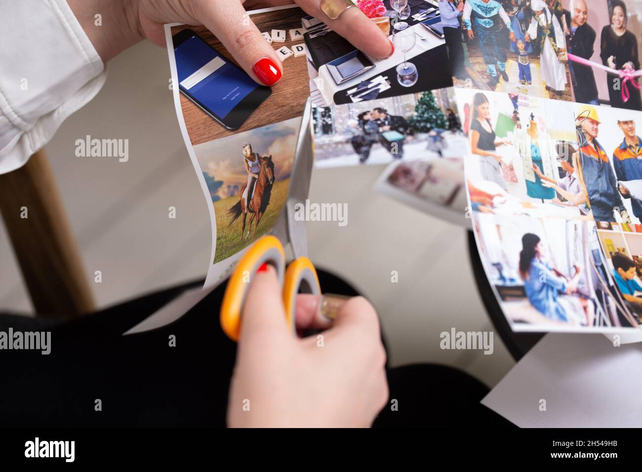 woman creating her Feng Shui wish map using scissors. Dreams and wishes ...