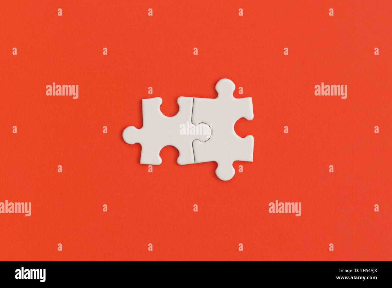 White details of puzzle on red background Stock Photo - Alamy
