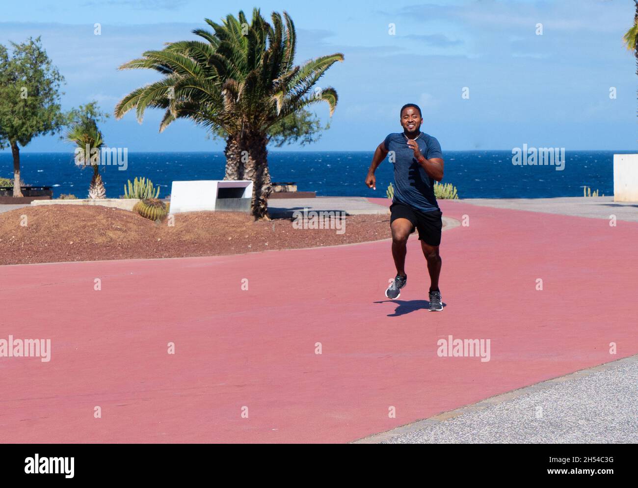 young healthy sportsman running outdoors at the beach Stock Photo - Alamy