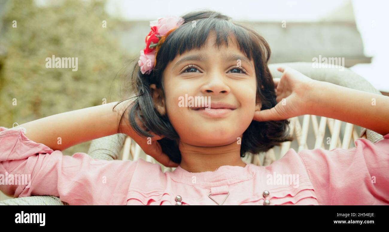 Portrait of a cheerful little girl from Inida outdoors Stock Photo - Alamy
