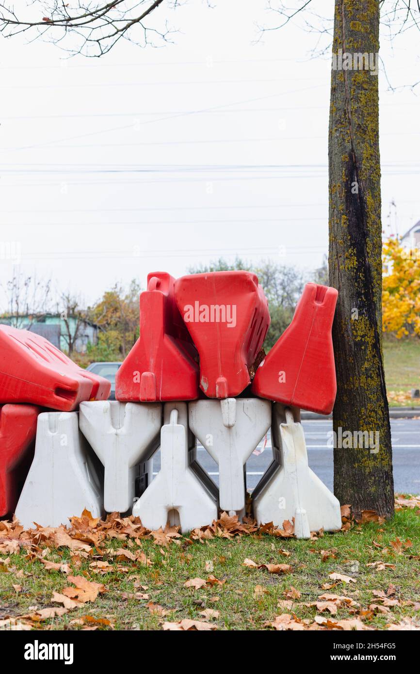 Red and white plastic road barriers. Construction props Stock Photo - Alamy