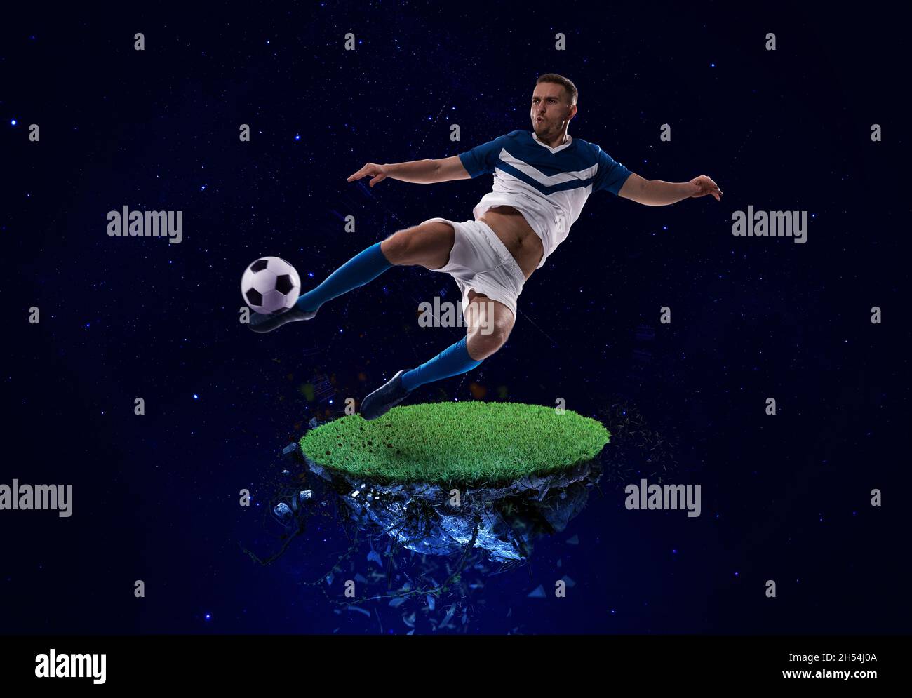 Football player kicks the soccer ball into space Stock Photo - Alamy