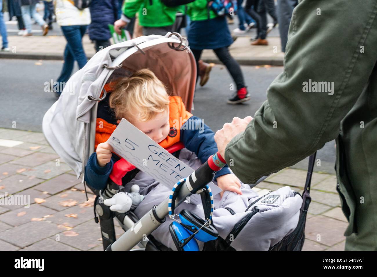 Amsterdam, Netherlands, November 06, 2021. Little boy in pram, pushed ...