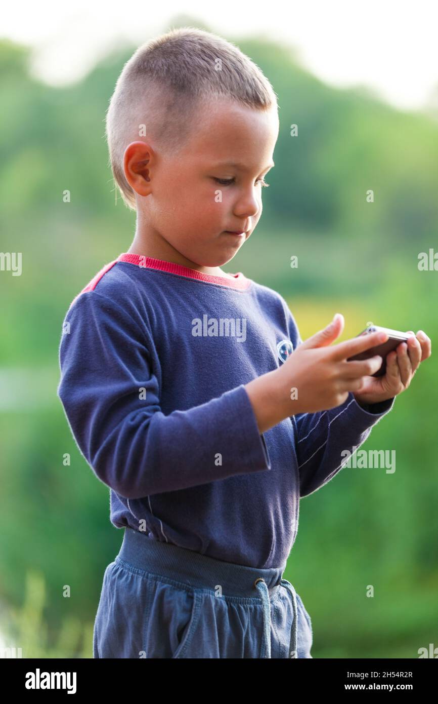 Child using a mobile phone Stock Photo - Alamy