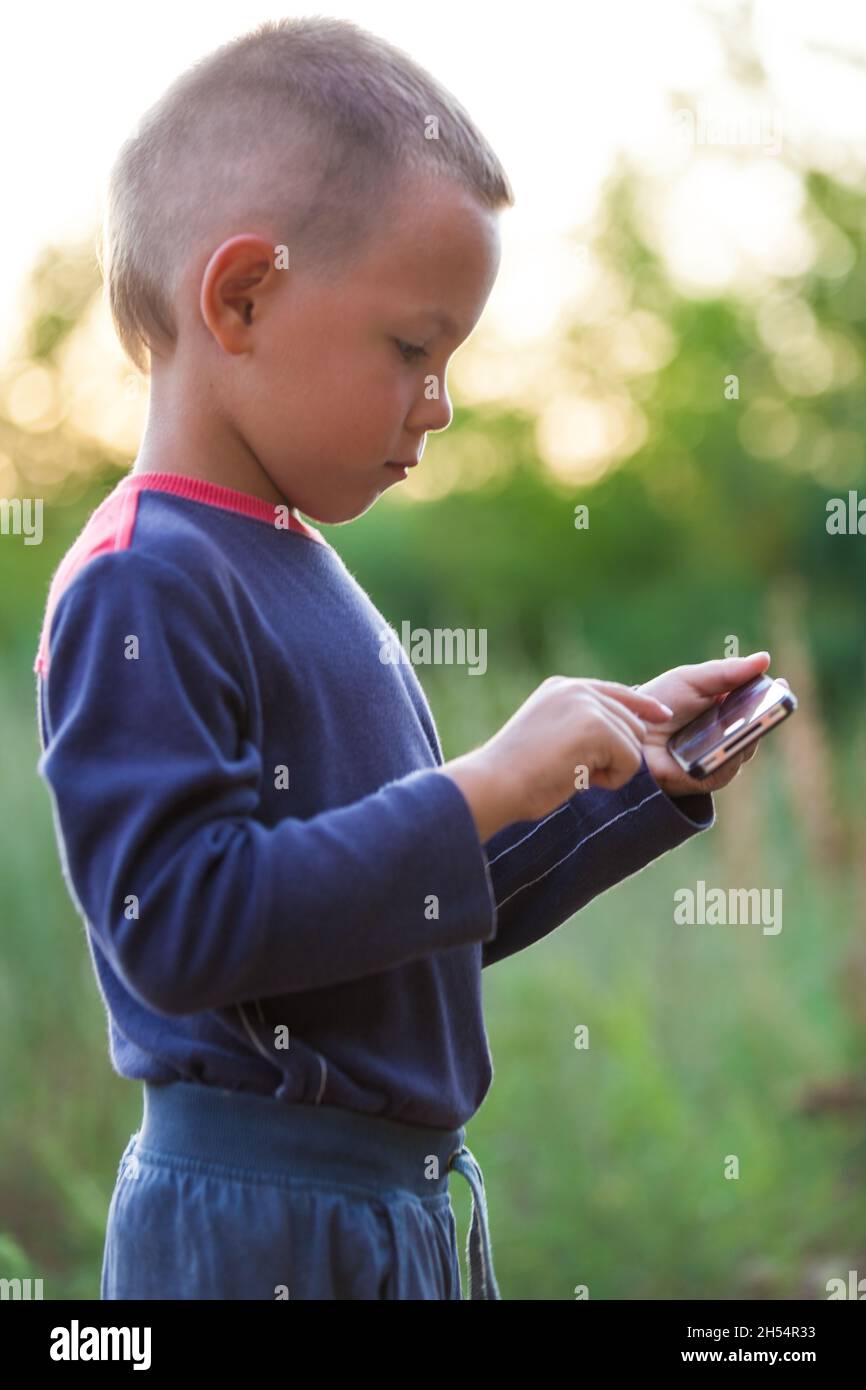 Child using a mobile phone Stock Photo - Alamy