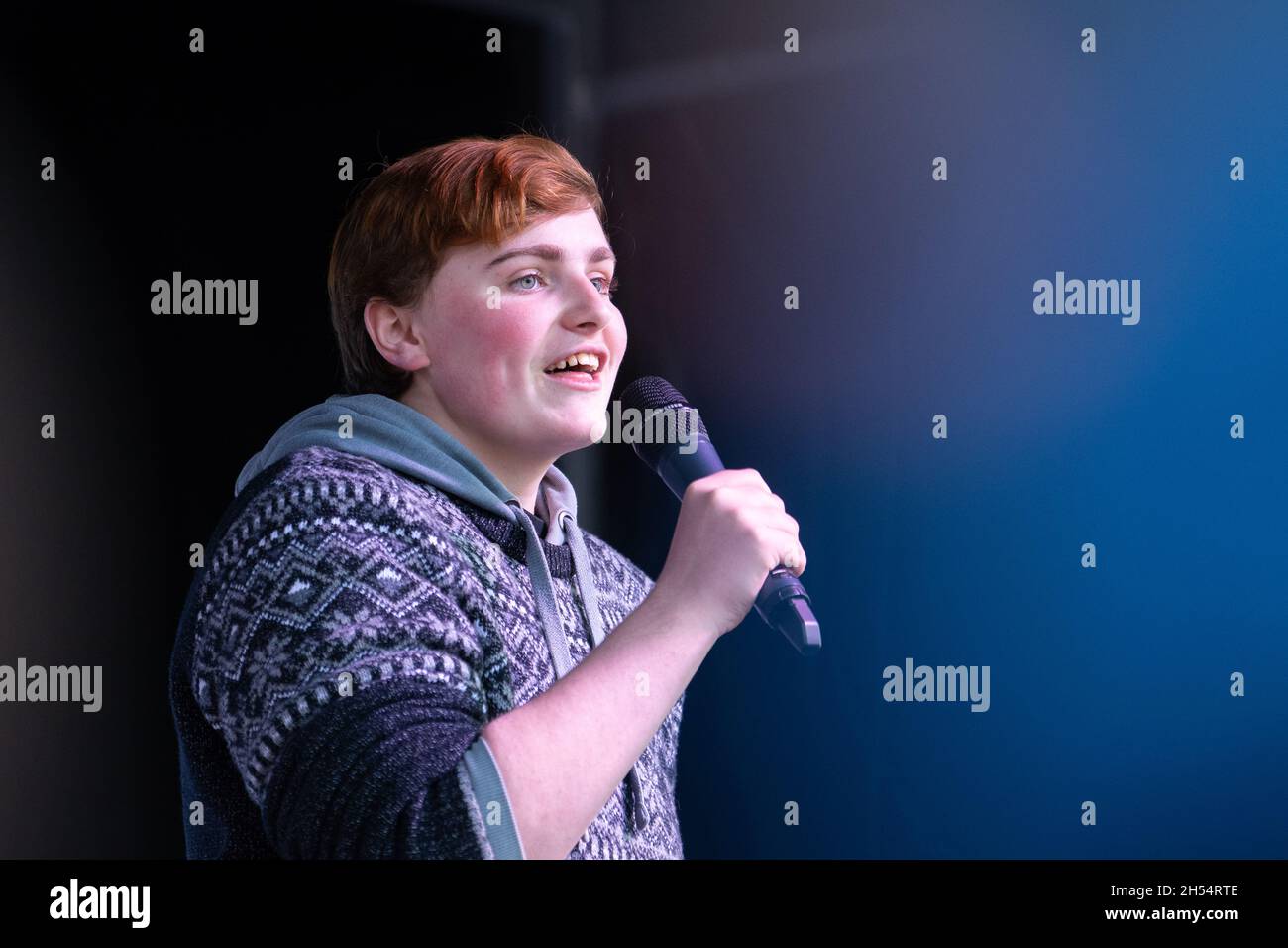 Dylan Hamilton Climate and Trans Rights Activist speaking on stage at ...