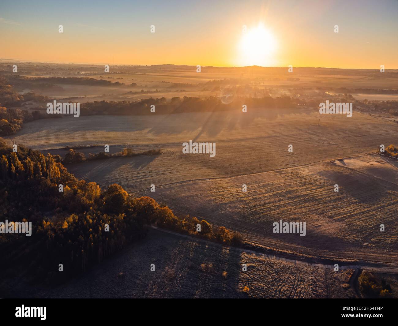 Aerial top-down view of autumn landscape at sunrise. There is a fine ...