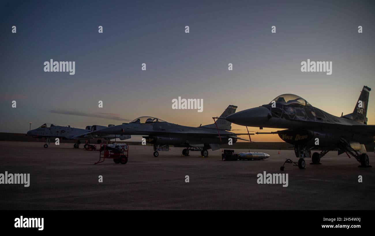 A U.S. Air Force A-10 Thunderbolt II sits next to two F-16 Fighting ...