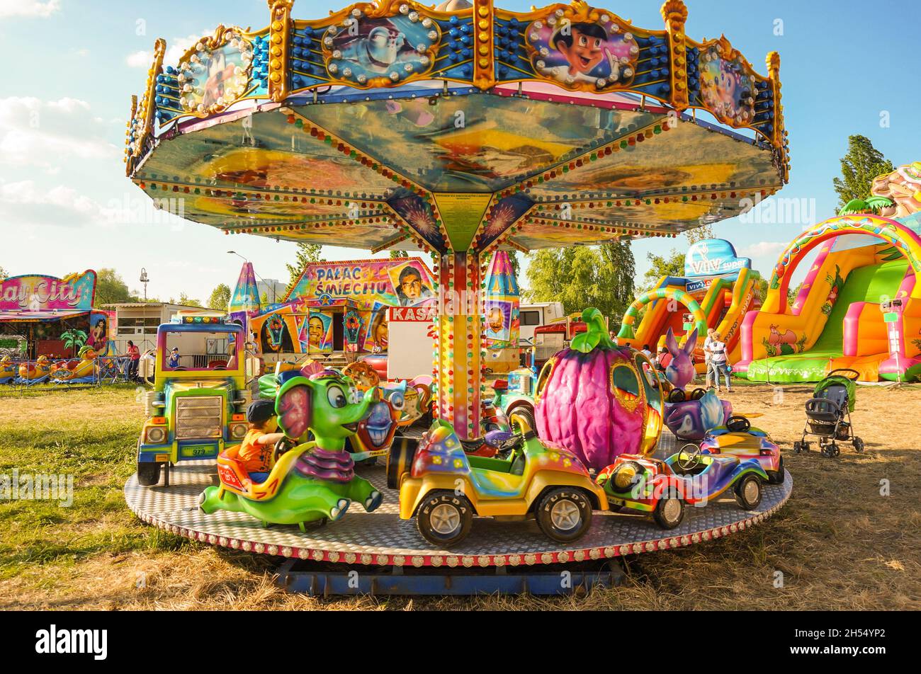 POZNAN, POLAND - May 22, 2016: A colorful carousel attraction with ...