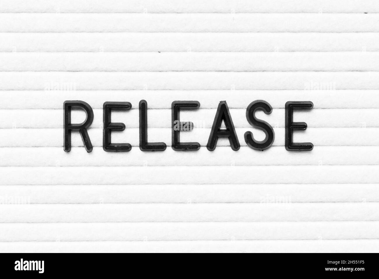 Black letter in word release on white felt board background Stock Photo ...