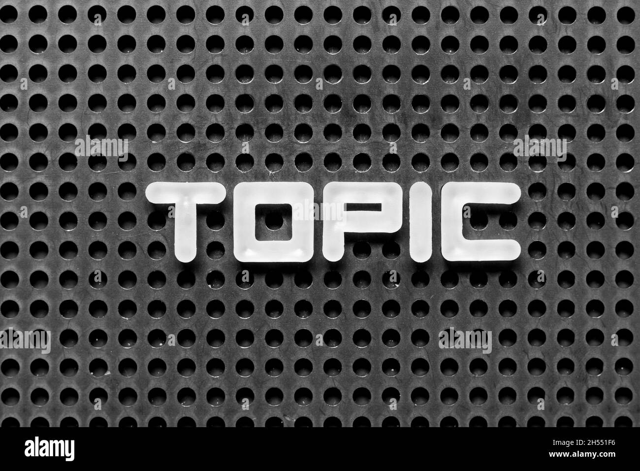 White alphabet letter in word topic on black pegboard background Stock ...