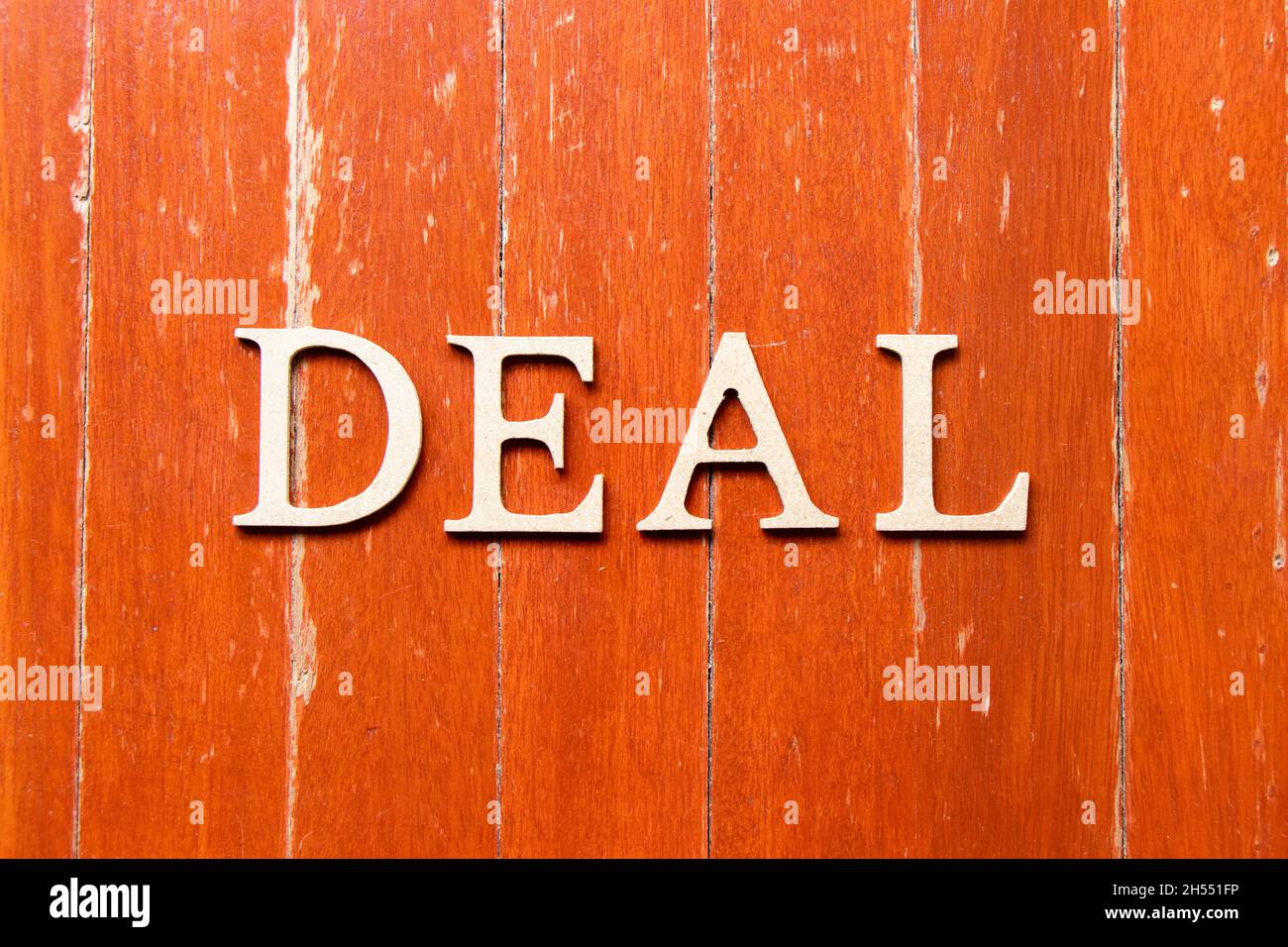 Alphabet letter in word deal on old red color wood plate background ...