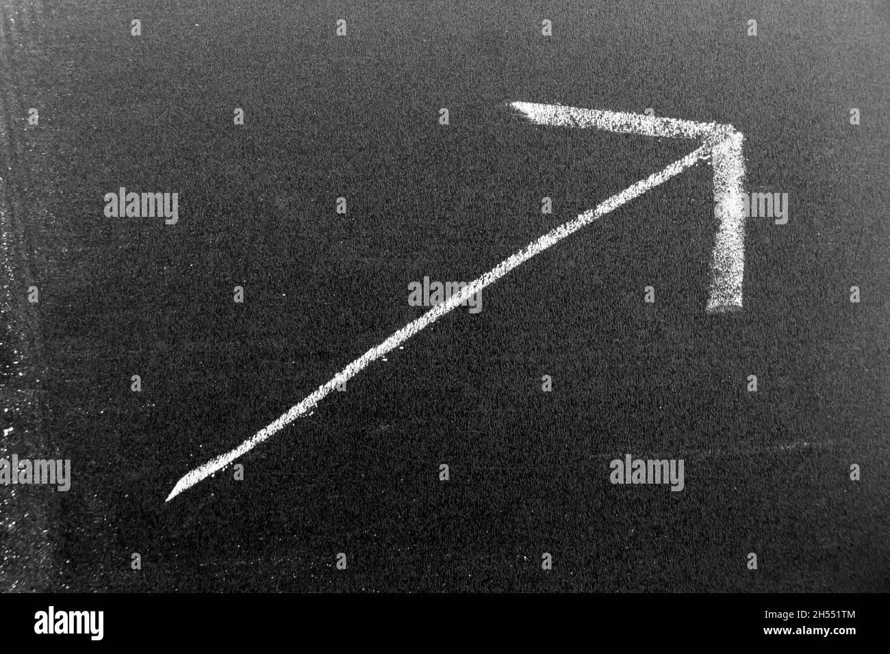 White color chalk hand drawing in shape on black board background ...