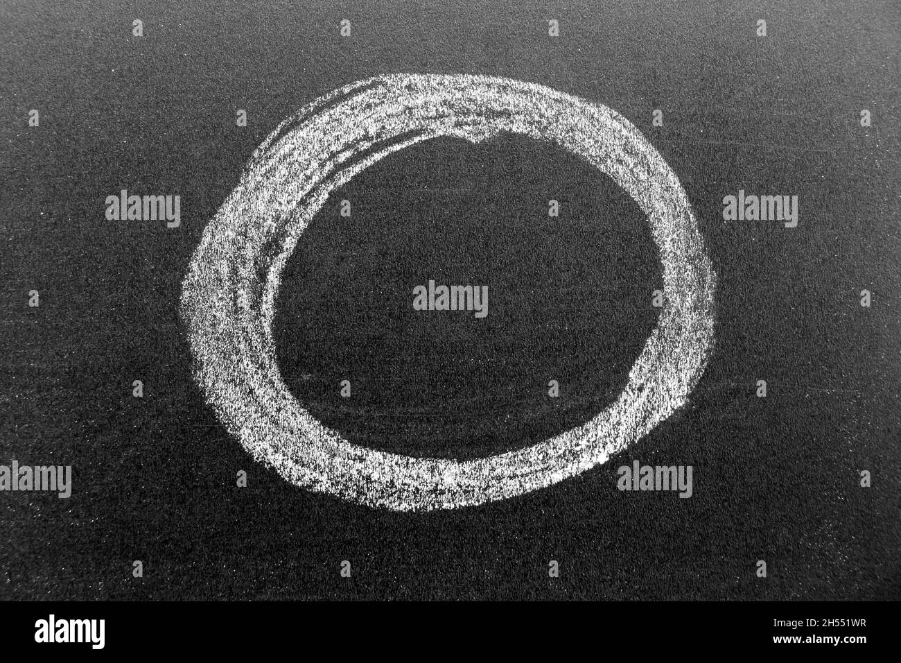 White chalk hand drawing as circle shape on black board background ...