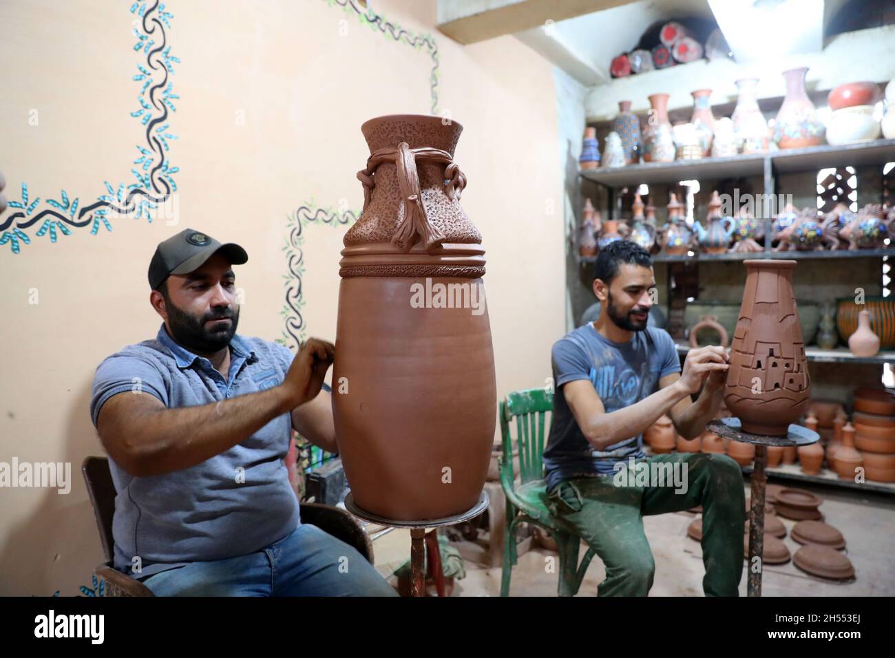 Cairo, Egypt. 6th Nov, 2021. Pottery craftsmen show pottery hollowed ...