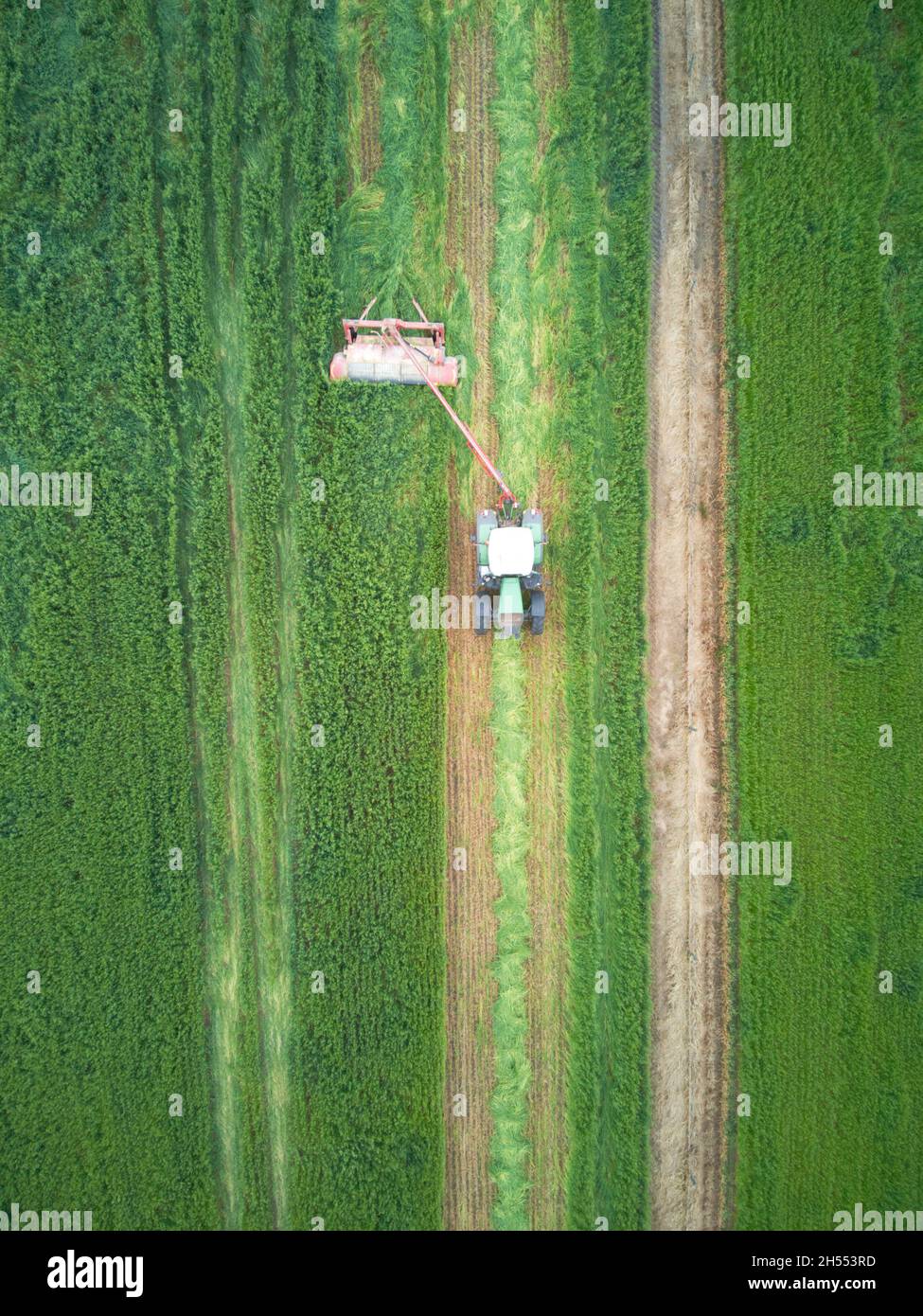 Tractor aerial view with background patterns, cutting oaten hay ...