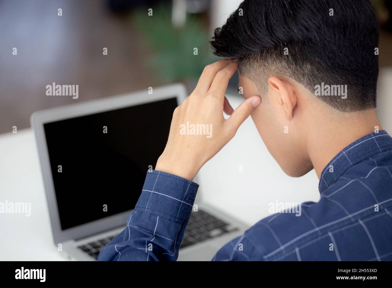 Young asian business man headache during working on laptop computer ...