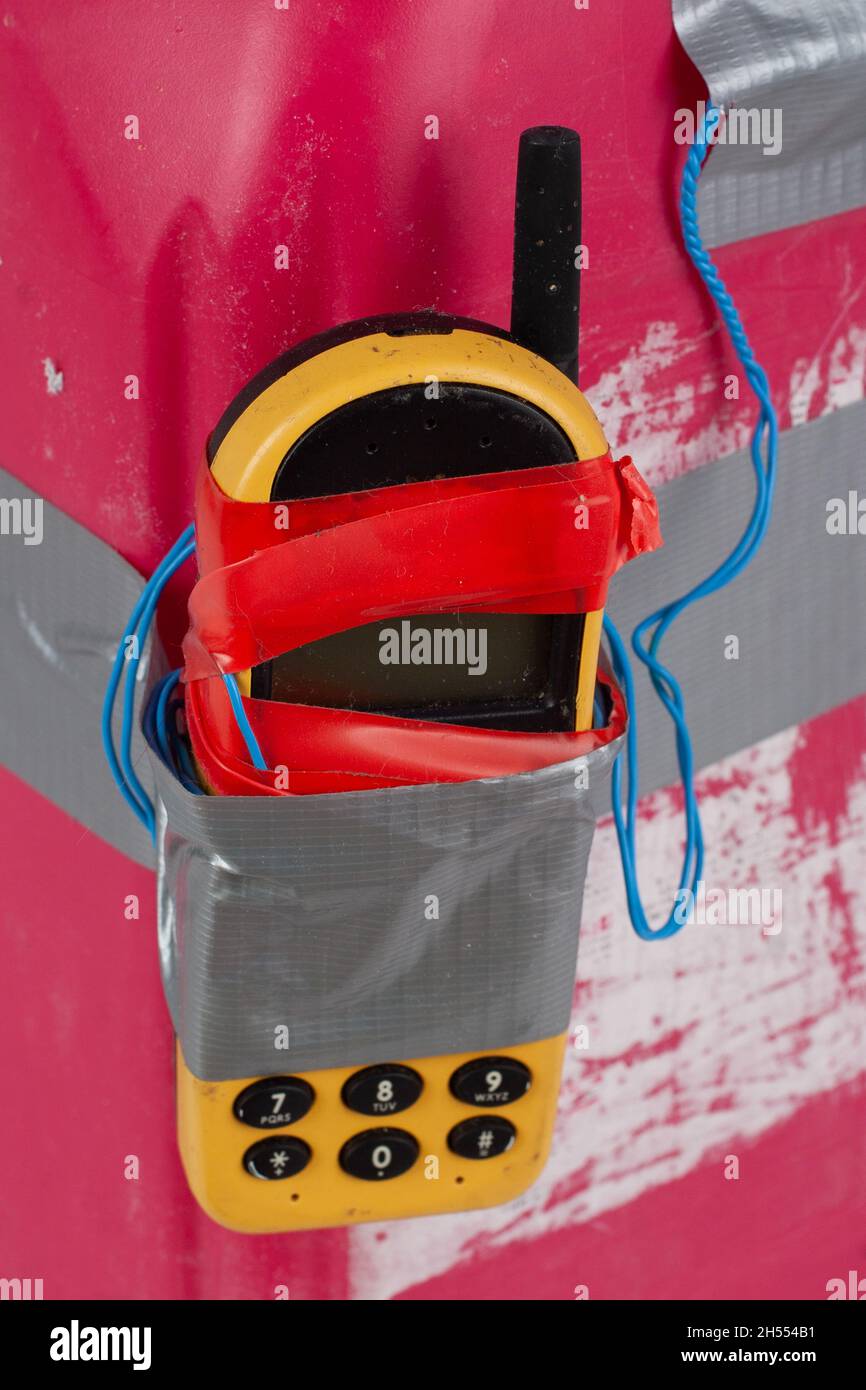 Red chemical jug IED bomb with cell phone fuse Stock Photo - Alamy