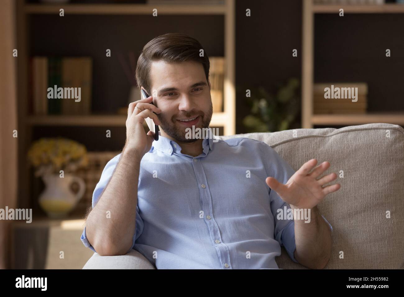 Happy Caucasian millennial man holding phone call conversation Stock ...