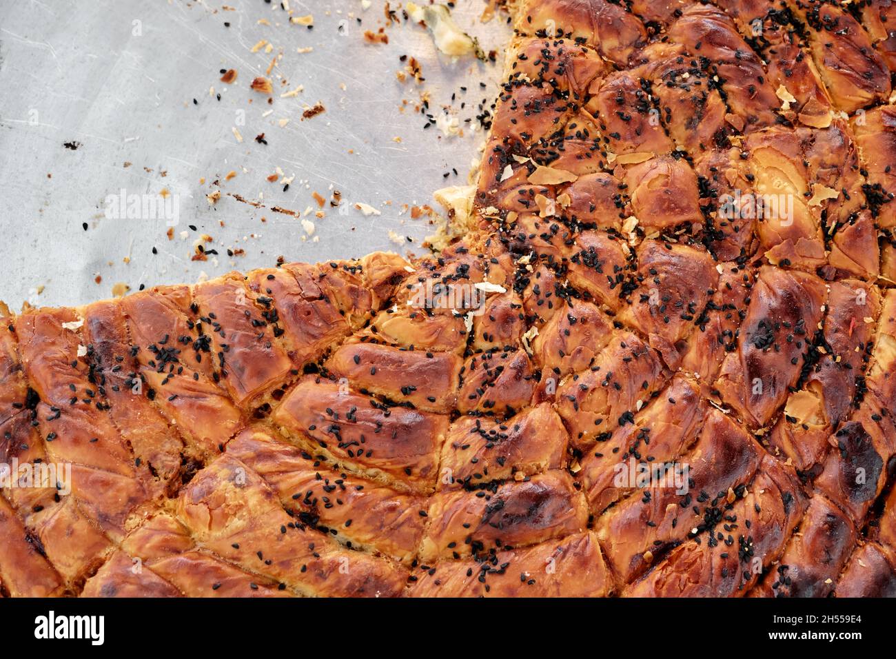 Traditional handmade Turkish patty with cheese and sesame in a baking ...