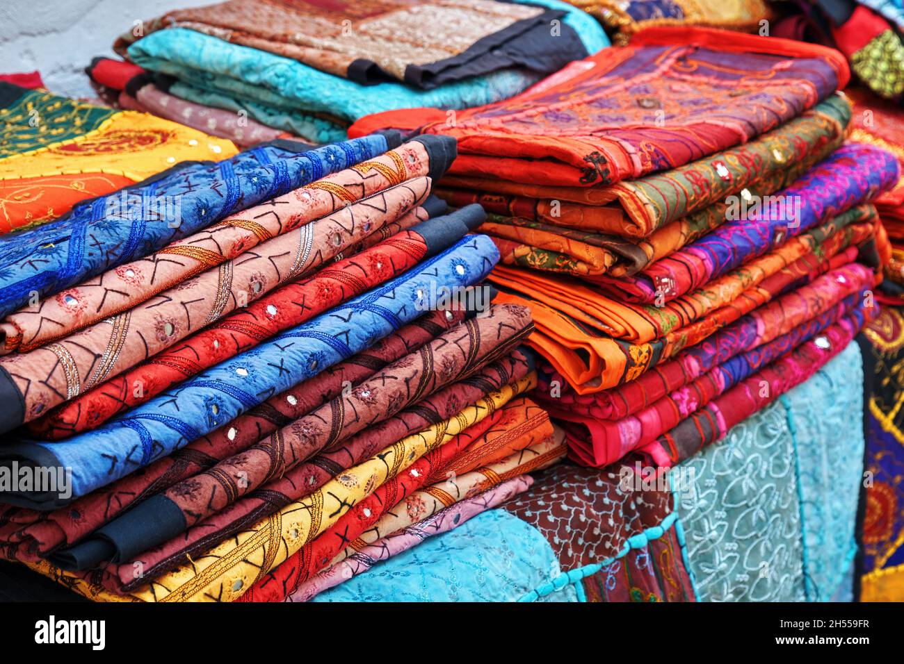 Authentic oriental colorful table clothes displayed at the counter ...