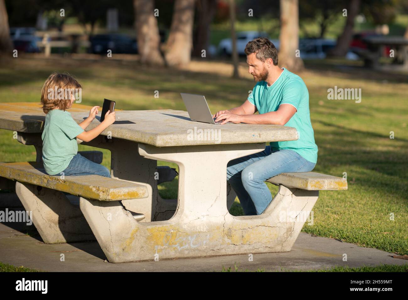 Father teaching son to use laptop, dad and school boy child looking ...