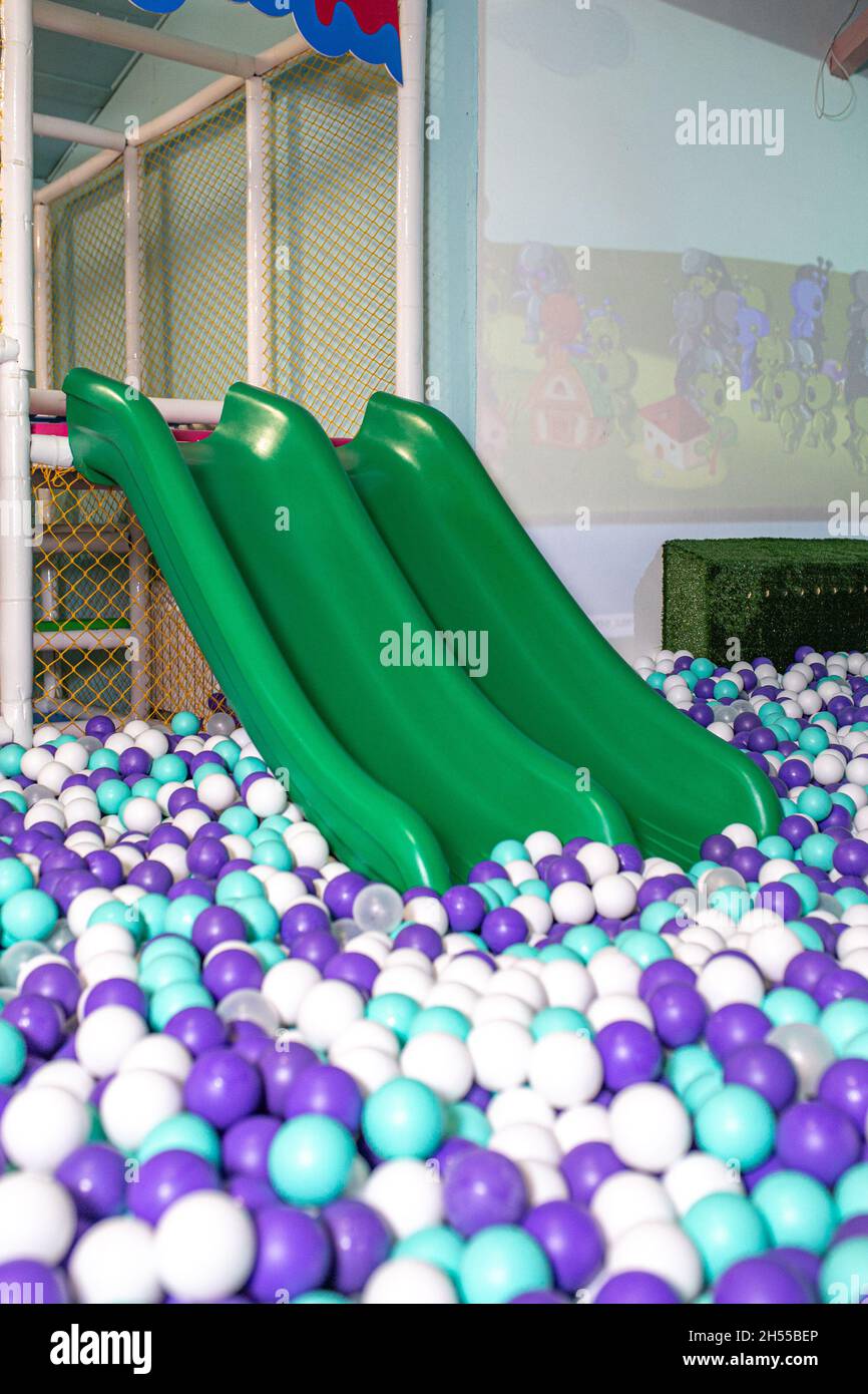 green plastic slide on the children's play area Stock Photo - Alamy