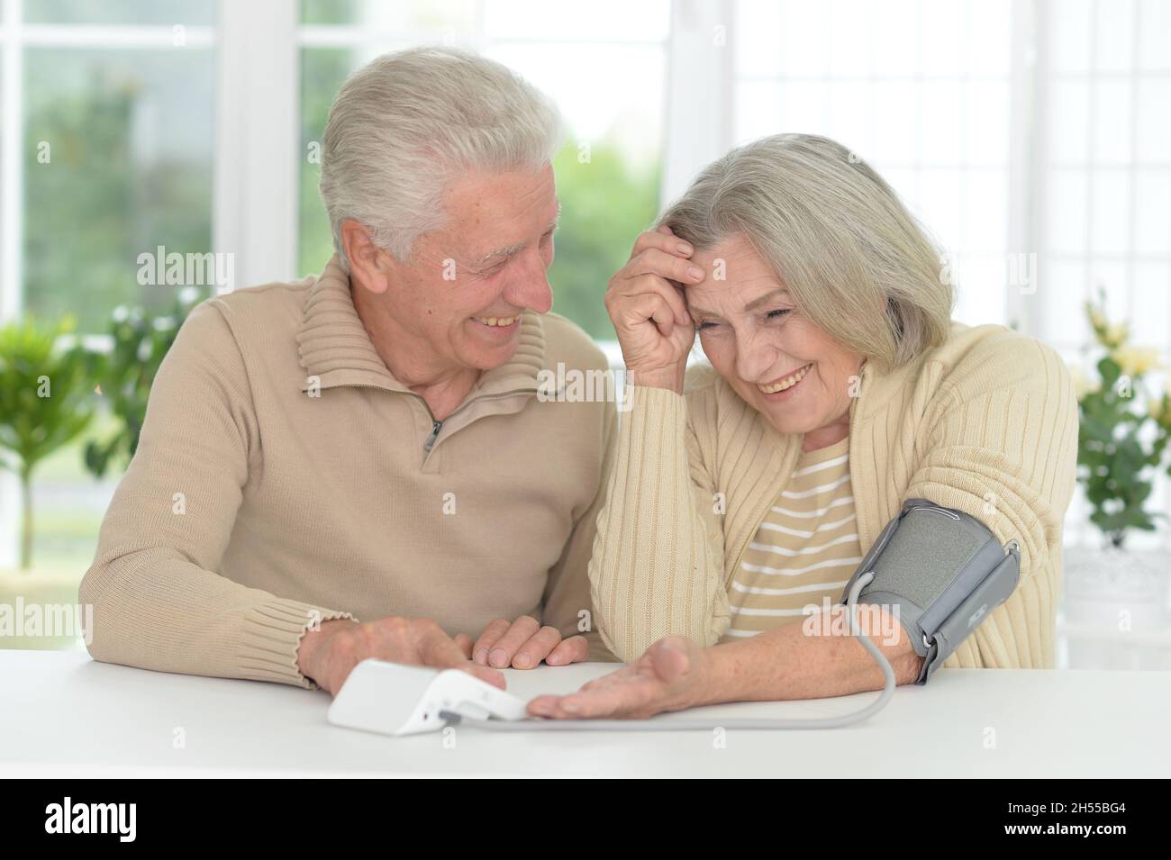 Portrait of senior couple measuring blood pressure together Stock Photo ...