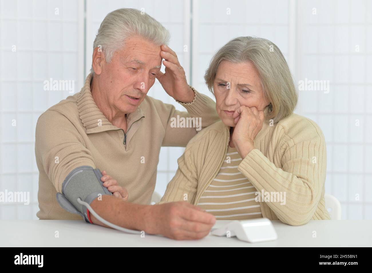 Portrait of senior couple measuring blood pressure together Stock Photo ...