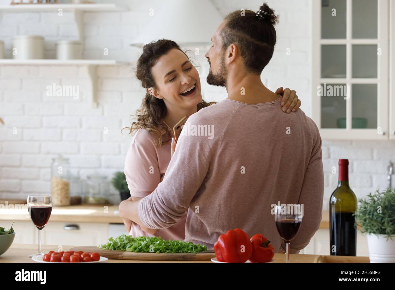 Happy millennial couple dancing in kitchen Stock Photo - Alamy