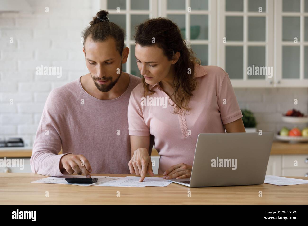 Focused concerned family couple managing budget Stock Photo - Alamy