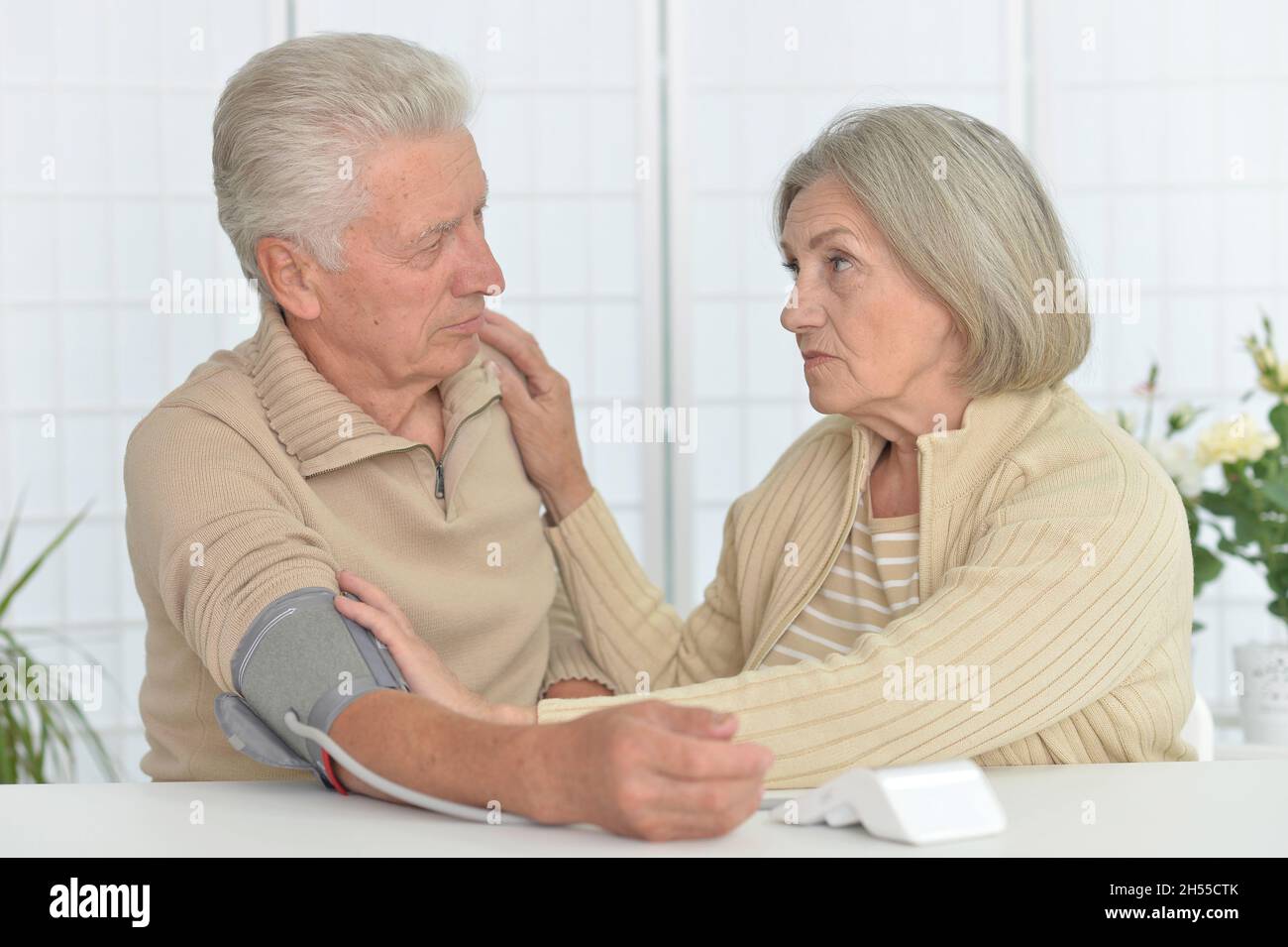 Portrait of senior couple measuring blood pressure together Stock Photo ...