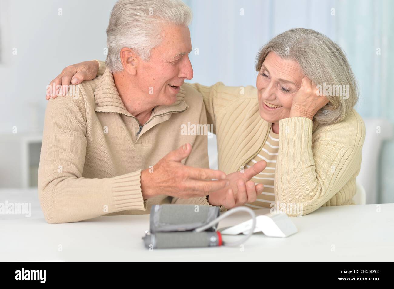 Portrait of senior couple measuring blood pressure together Stock Photo ...