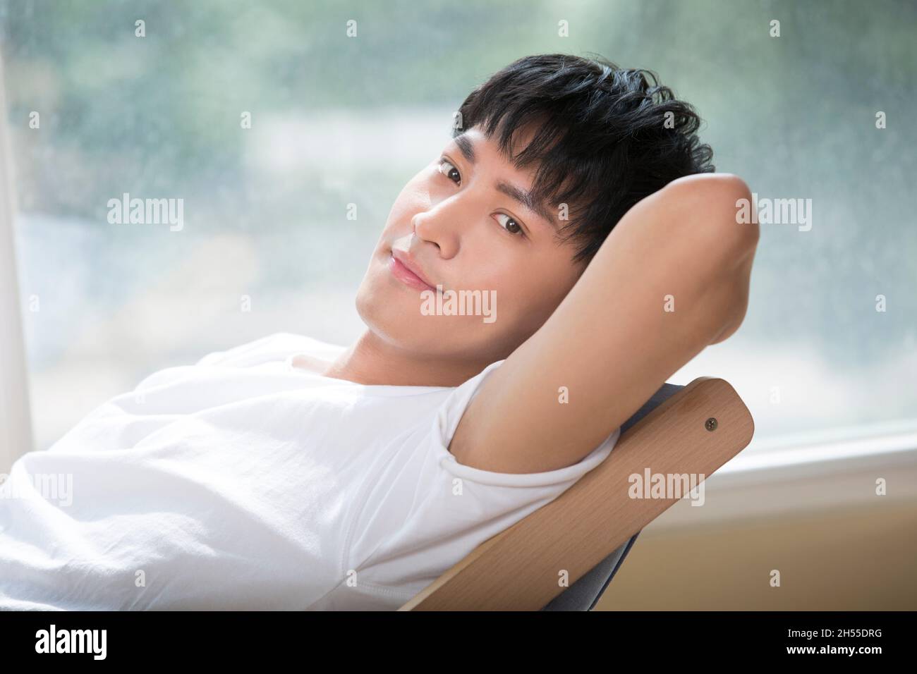 Young man restingon the recliner Stock Photo - Alamy