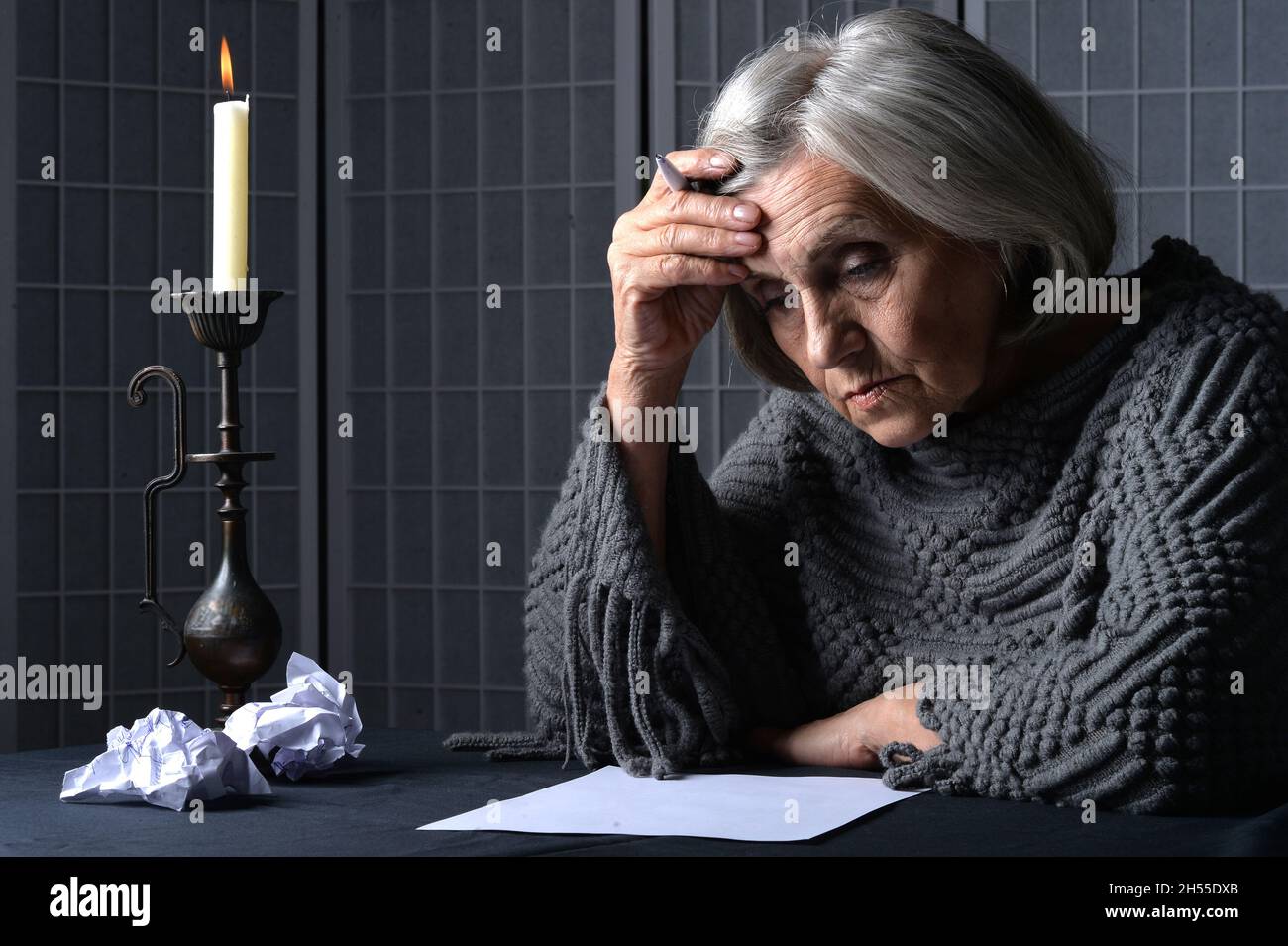 Portrait of sad senior woman writing letter Stock Photo - Alamy