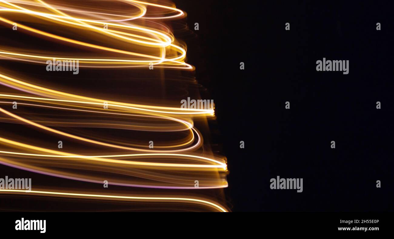 Gold neon festive lines on black background Stock Photo - Alamy