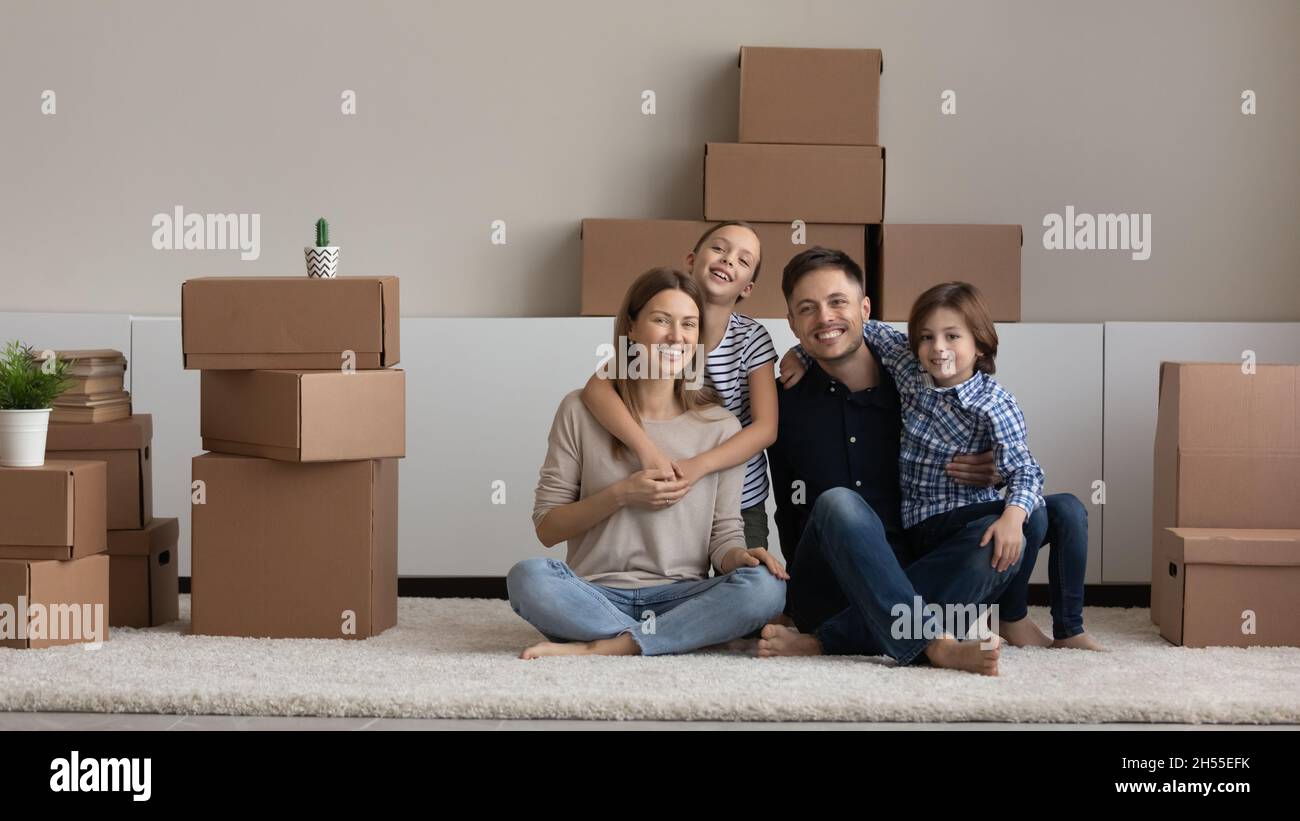 Portrait of happy family with kids enjoying moving day Stock Photo - Alamy