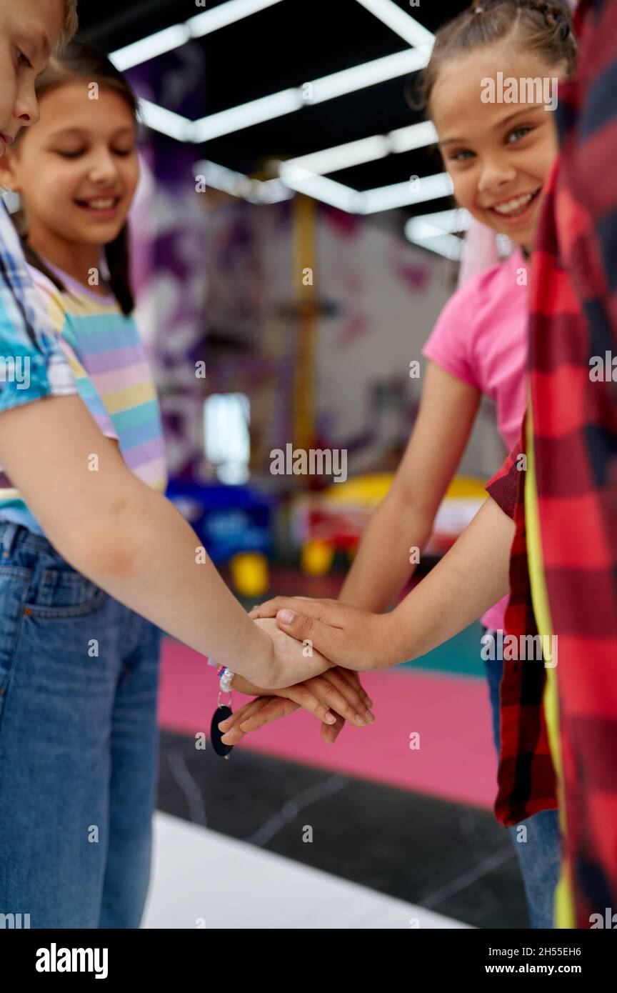 Children hold hands on playground, top view Stock Photo - Alamy