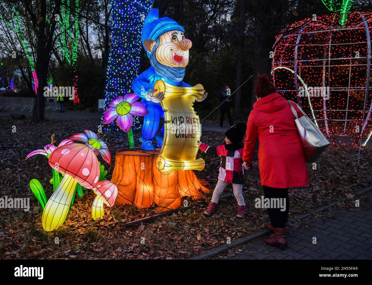 A kid playing with illuminated animations, at the garden of lights ...