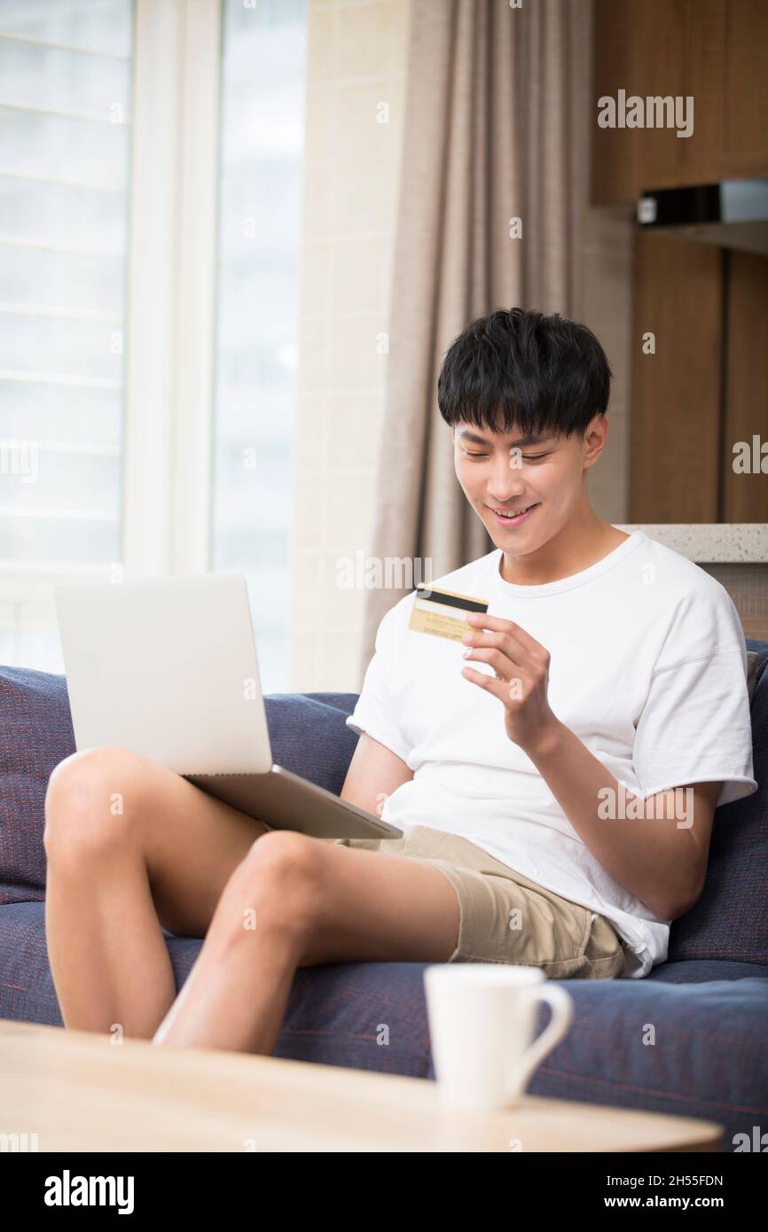 Young and handsome man shopping online Stock Photo - Alamy